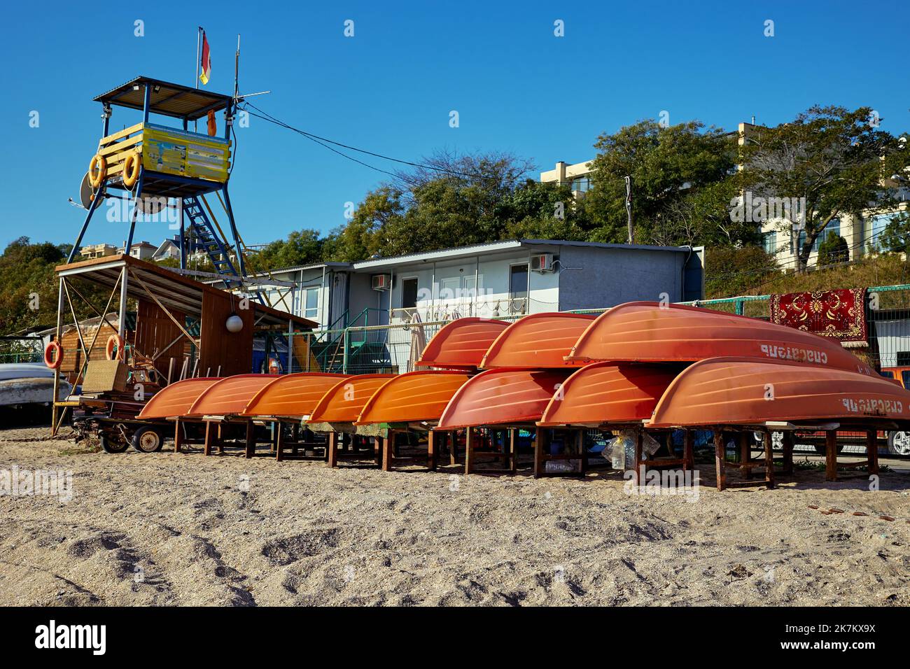 Lifeboats labeled Rescuer are overturned and stacked. Rescue tower and ...