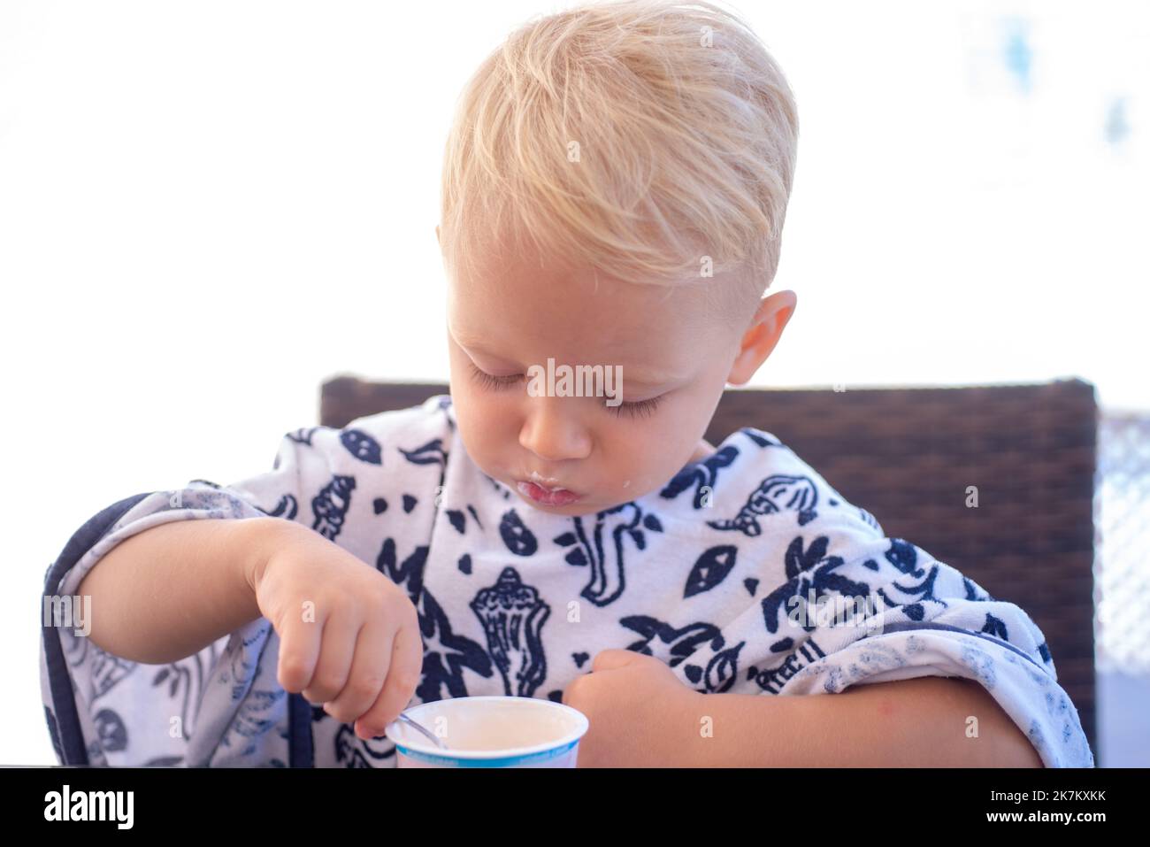 Baby food, babies eating. Little boy eating yogurt Stock Photo - Alamy
