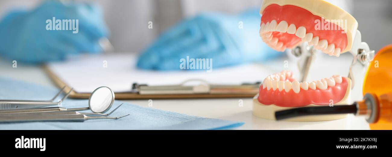 Dentist fills out a patient medical examination card in dental clinic ...