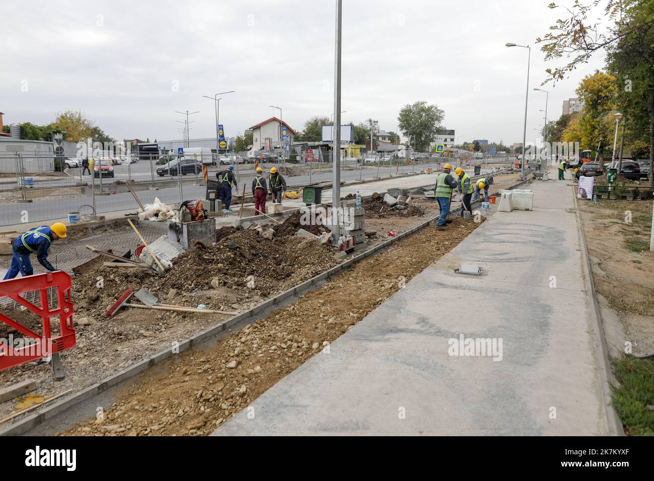Bucharest, Romania - October 12, 2022: Workers at a road construction site in the Prelungirea ...