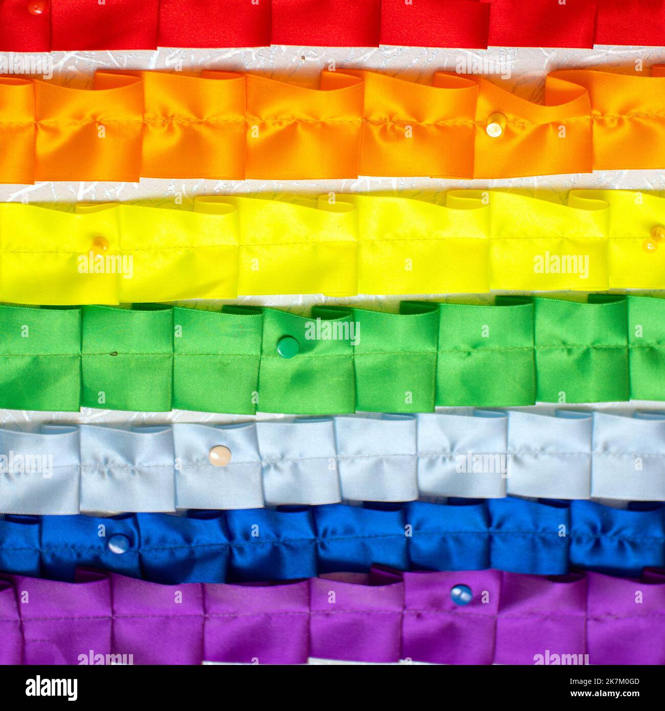 Rainbow of folded nailed or pinned ribbons Stock Photo - Alamy