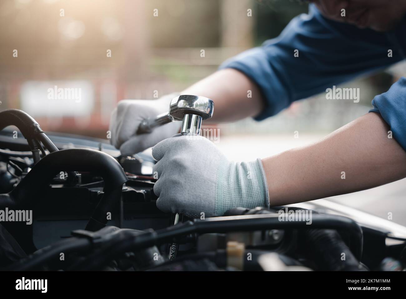 Service outdoor. Close up hands of auto mechanic man working on car ...