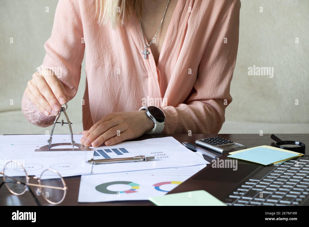 The girl sits at her desk and draws up graphs and histograms about ...