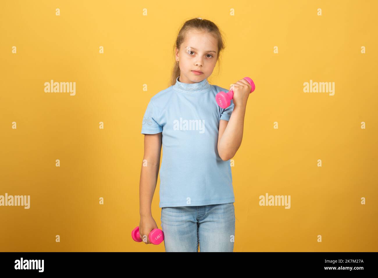 Fitness dumbbells kid exercise workout. Girl sporty child with ...