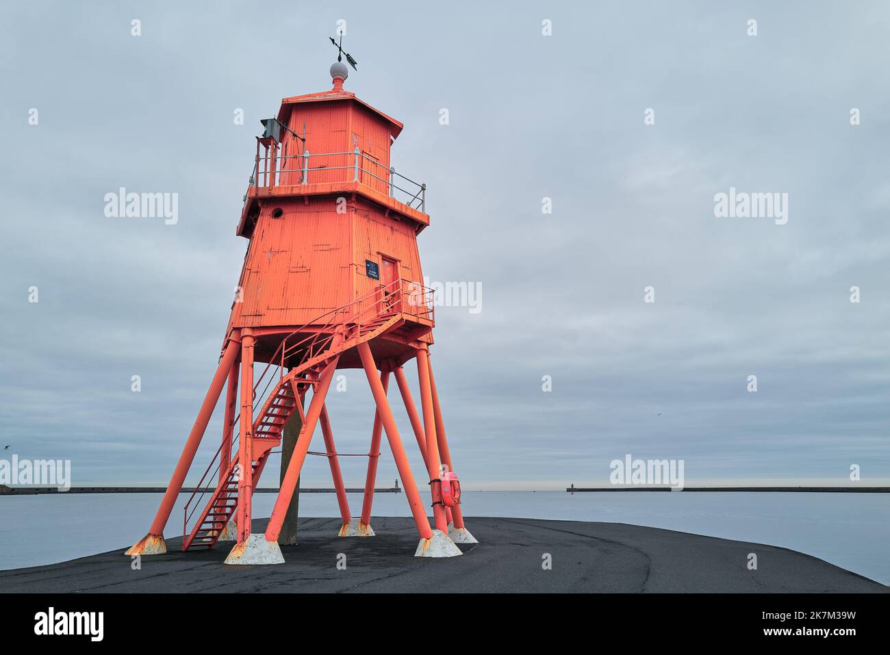 The red Herd Groyne lighthouse at the mouth of the river Tyne, South ...