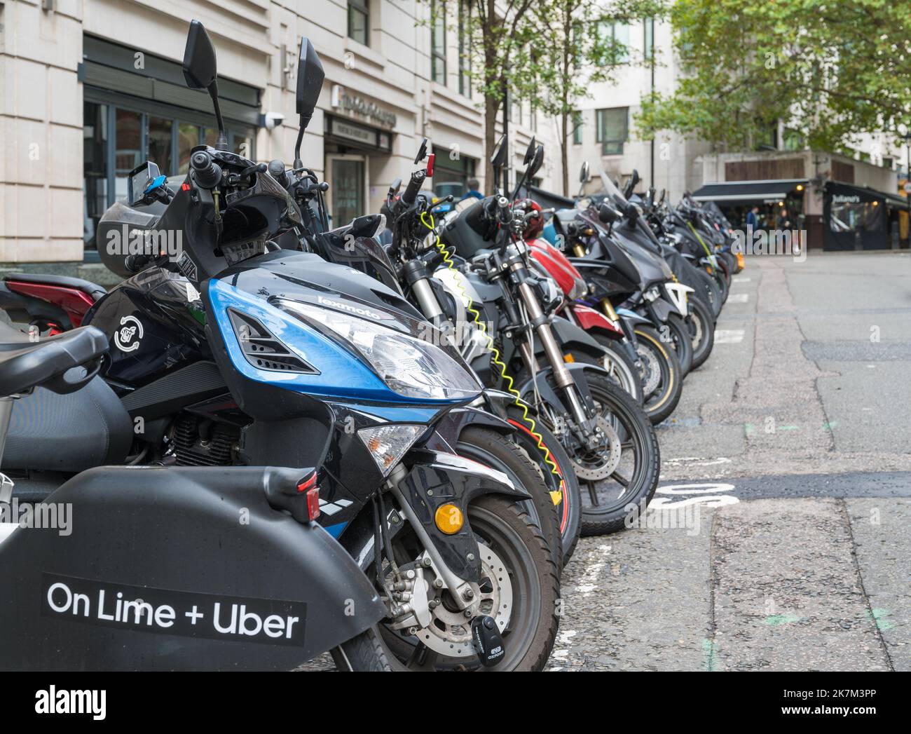 Row of parked motorcycles in Charles Street, Mayfair, London, England ...
