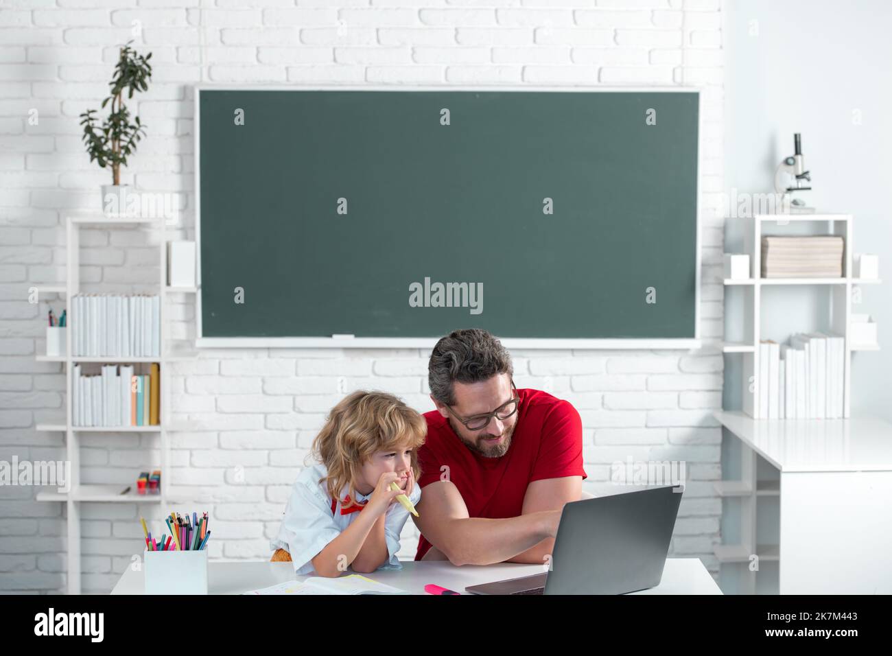 First day at school. Cute little boy studying lesson in class. Pupil of ...