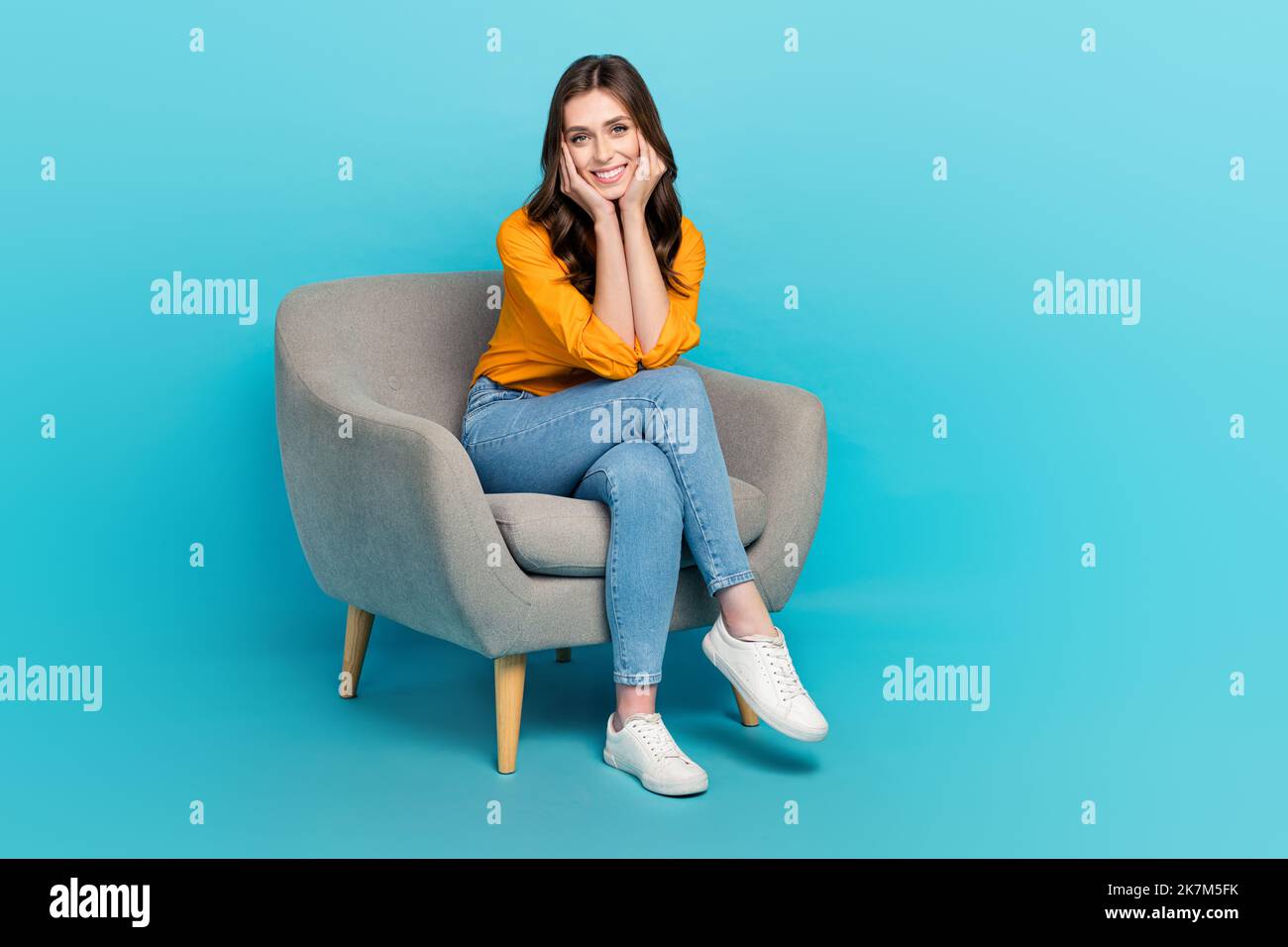 Full length portrait of gorgeous satisfied lad sit chair arms touch ...