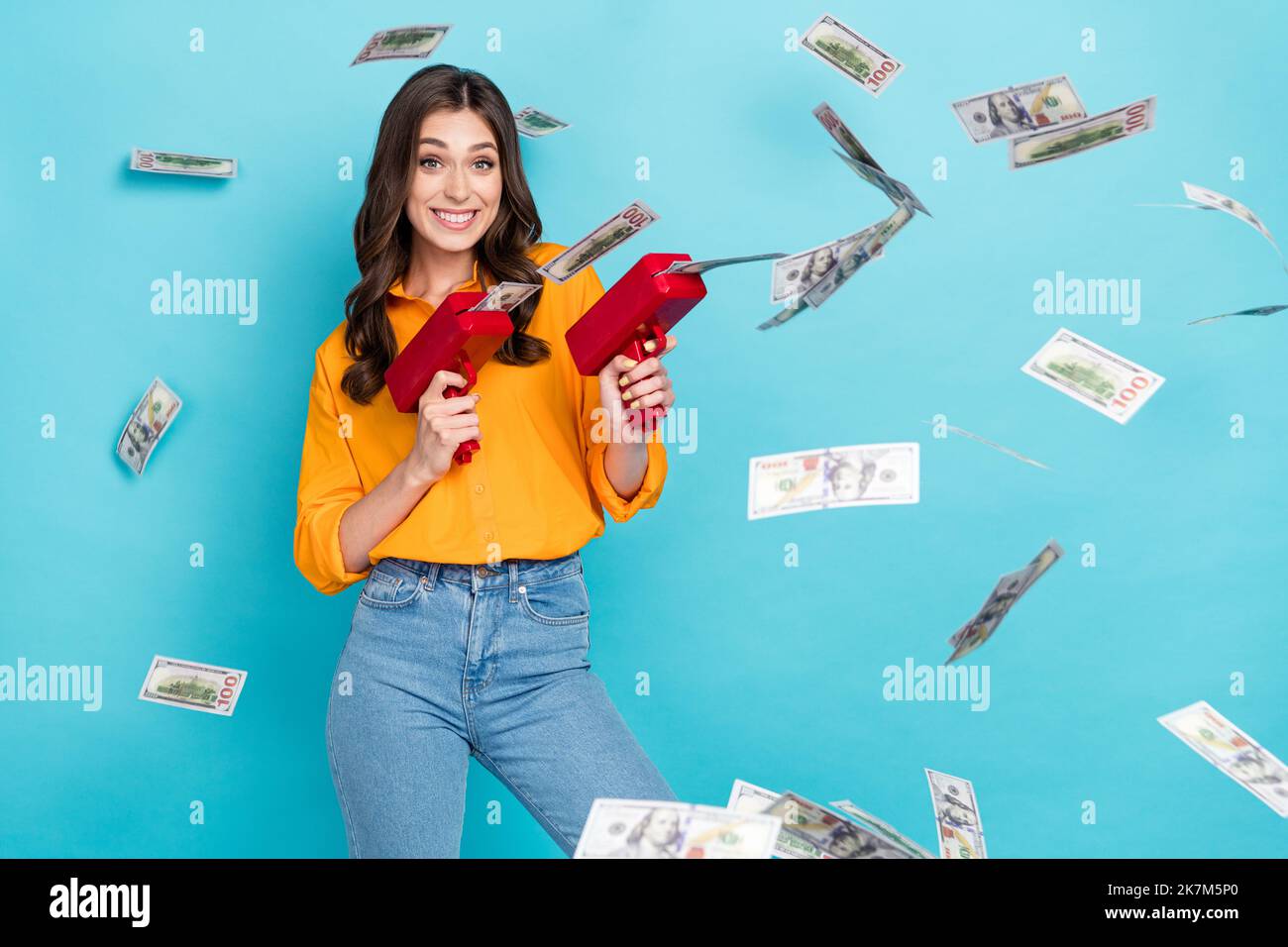 Portrait of excited successful person hold money gun shooting banknotes ...