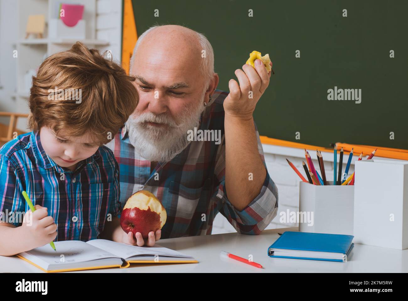Grandfather and grandson child learning write and read at school ...