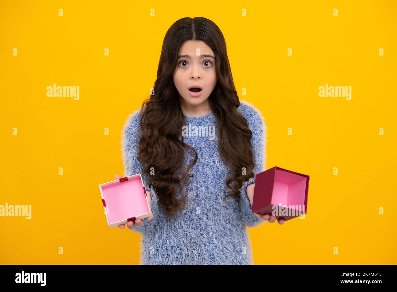 Child with gift present box on isolated studio background. Gifting for ...