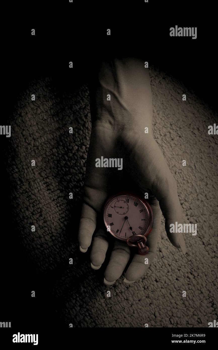 womans open hand holding a pocket watch laying on a carpeted floor ...