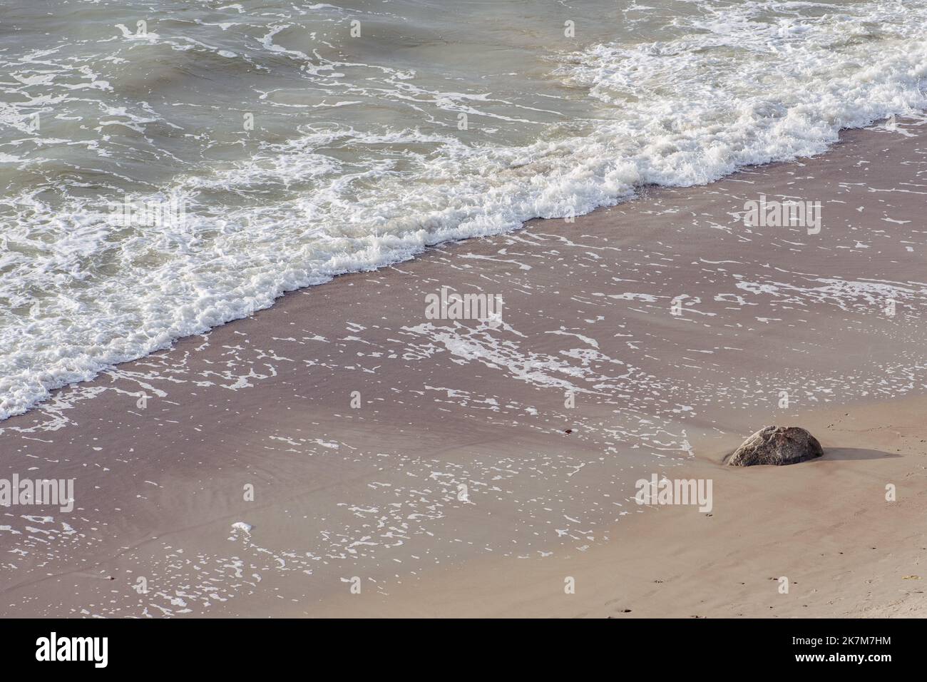 Beautiful sandy beach on the Baltic Sea with a big granite stone an d ...
