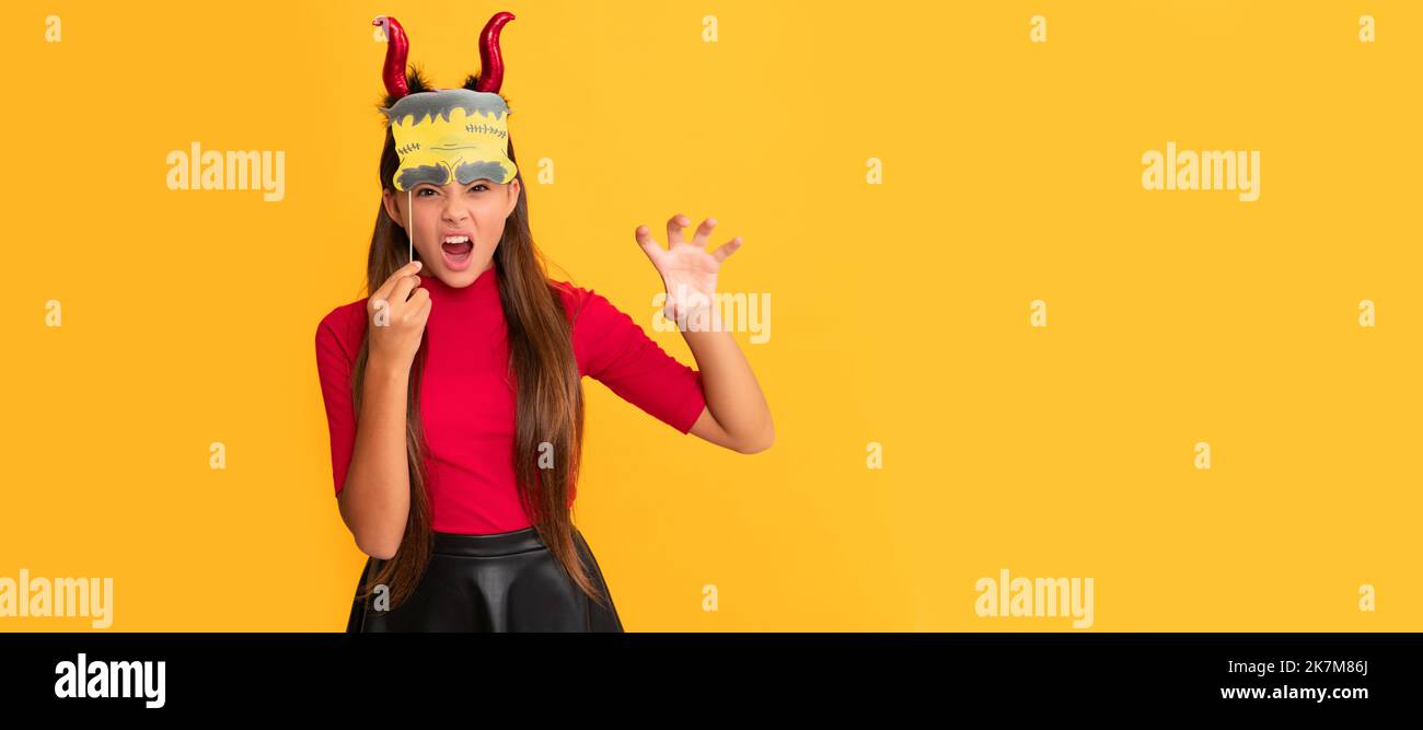 evil child in imp horns with party accessory. Halloween kid girl ...