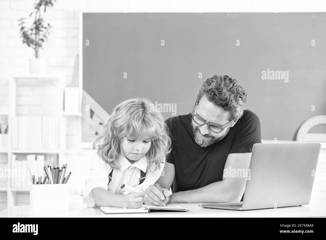 teacher man and kid study in classroom with laptop, fatherhood Stock ...