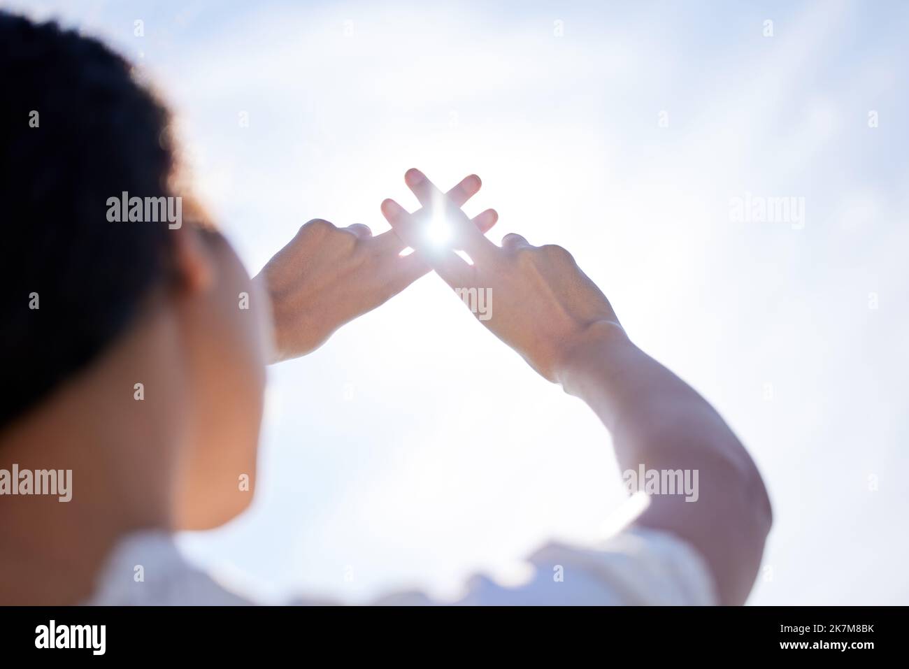 Praise the sun gods. Low angle shot of a woman holding her hands up to ...