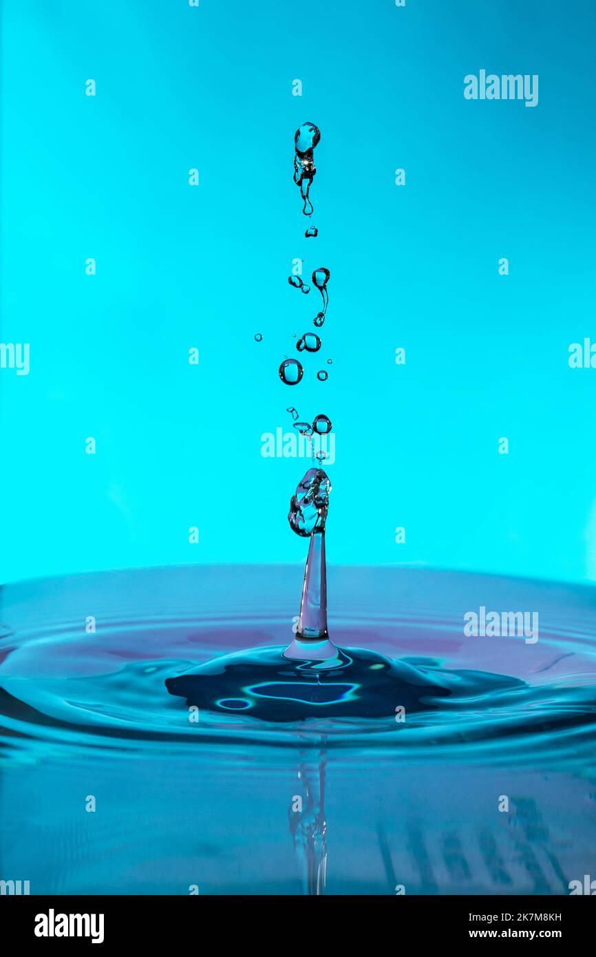 Close-up water drops falling and impacting a body of water Stock Photo ...