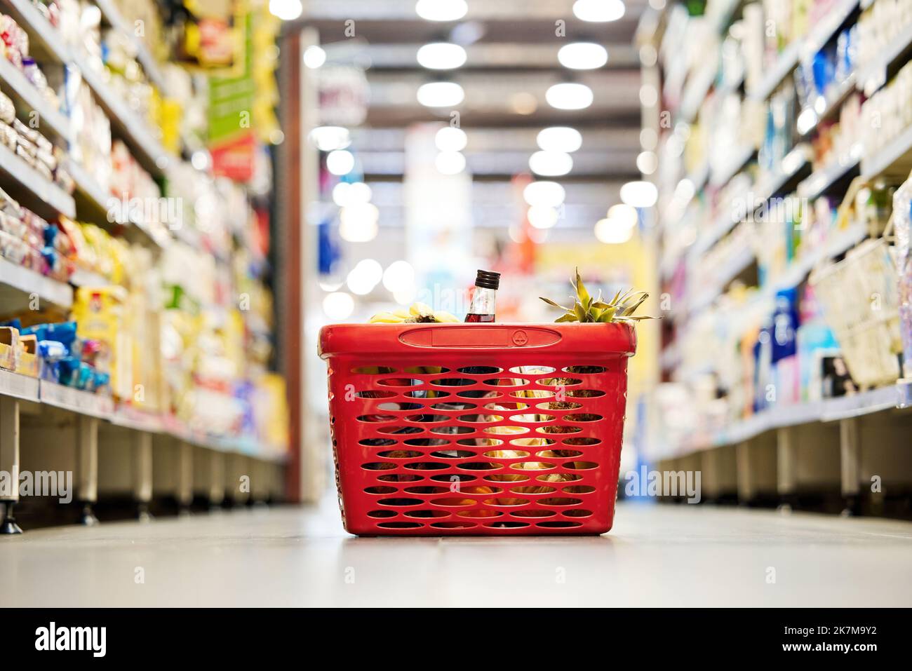 The aisle of goodnes. a shopping basket on the floor of a grocery store ...