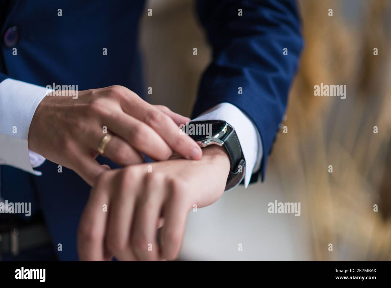 businessman checking time on his wrist watch, man putting clock on hand ...