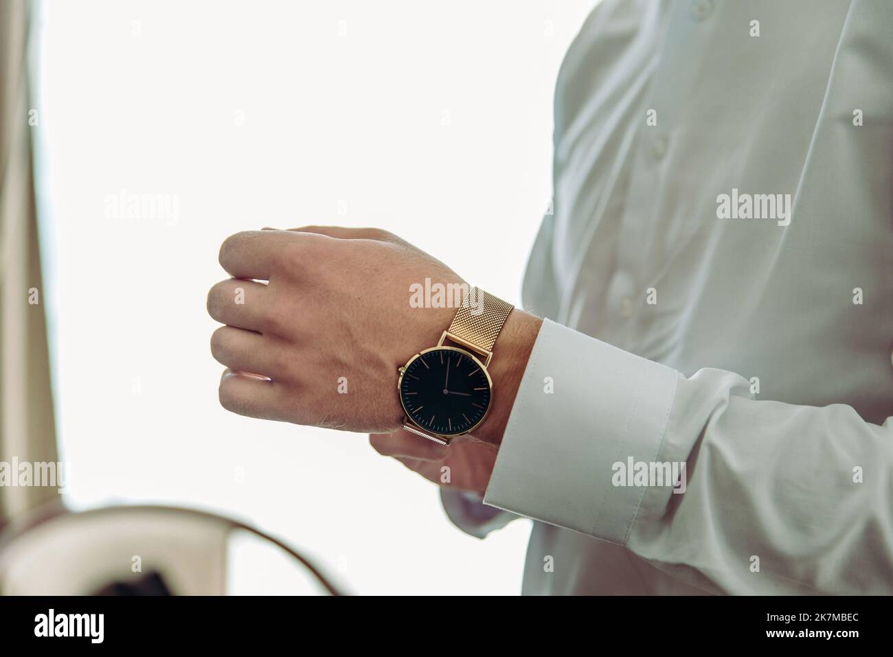 businessman checking time on his wrist watch, man putting clock on hand ...