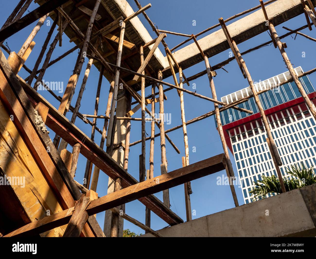 Temporary wooden pole for supports the concrete structure of a building ...