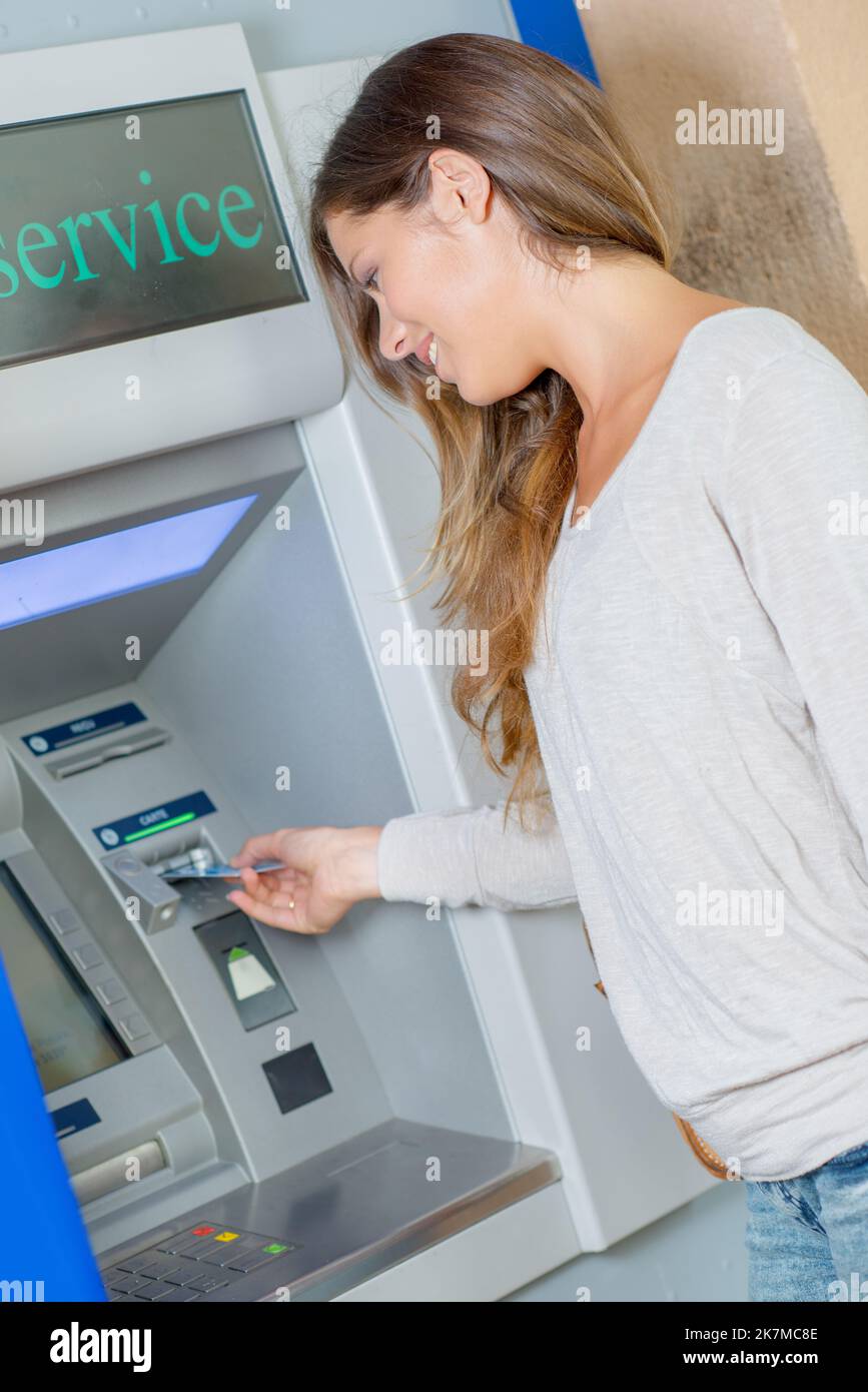 Withdrawing money from a cash machine Stock Photo - Alamy