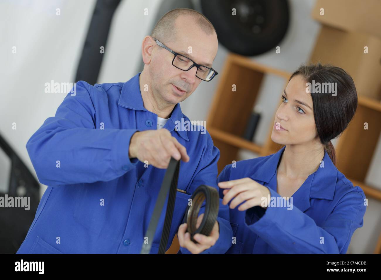 female apprentice and teacher working on a car engine Stock Photo - Alamy