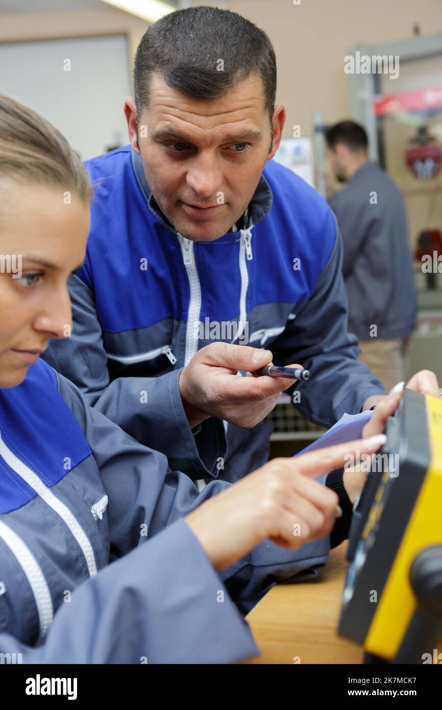 man mechanic and woman discussing repairs Stock Photo - Alamy
