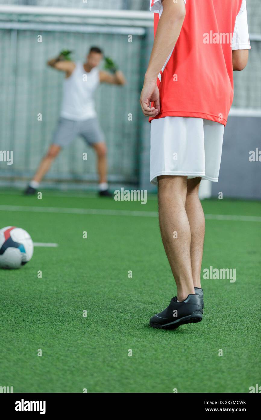 rear view of young men playing football indoors Stock Photo - Alamy