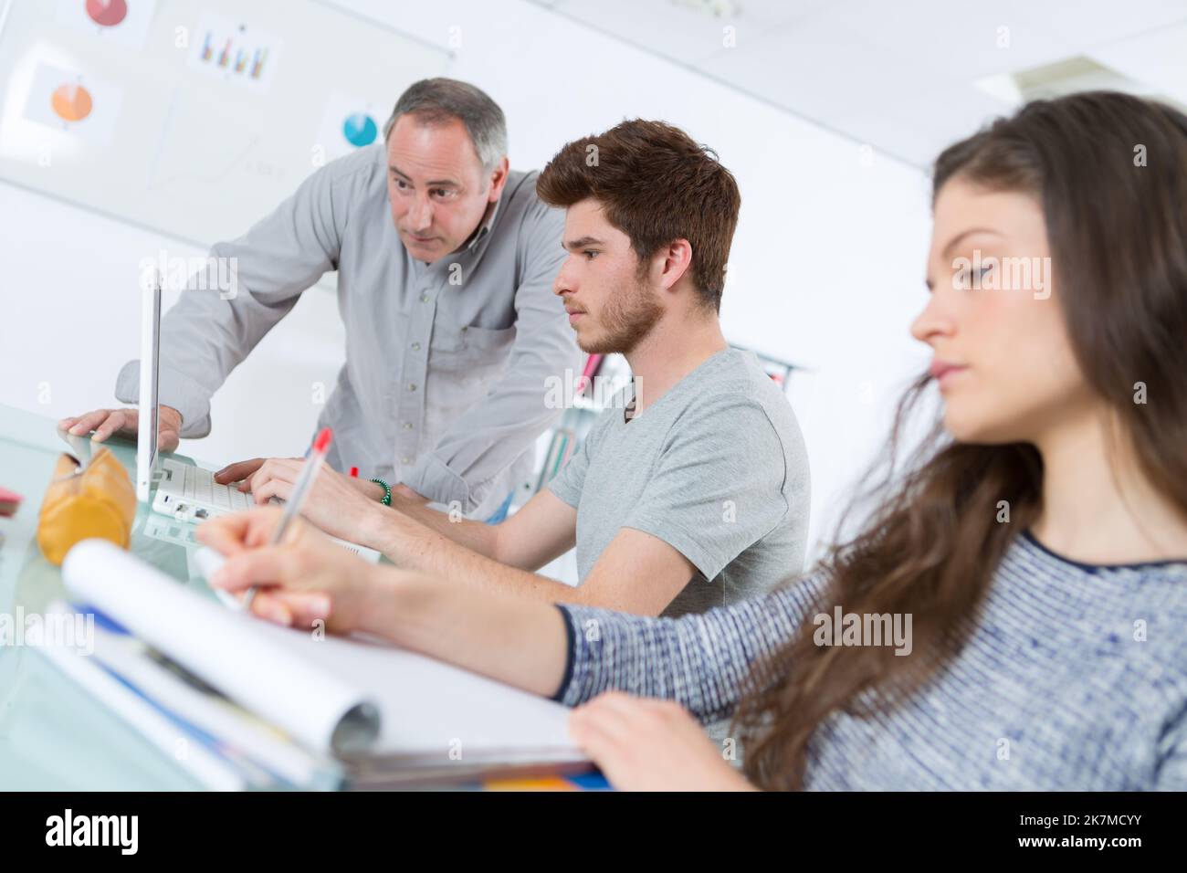 teacher in classroom with students Stock Photo - Alamy