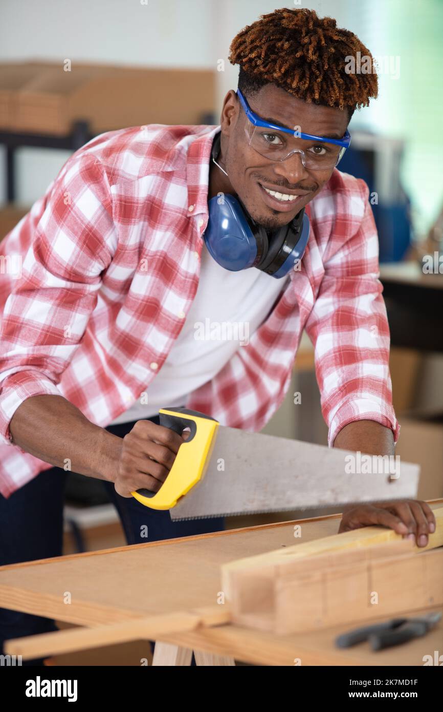 skilled carpenter cutting wood in his woodwork workshop Stock Photo - Alamy