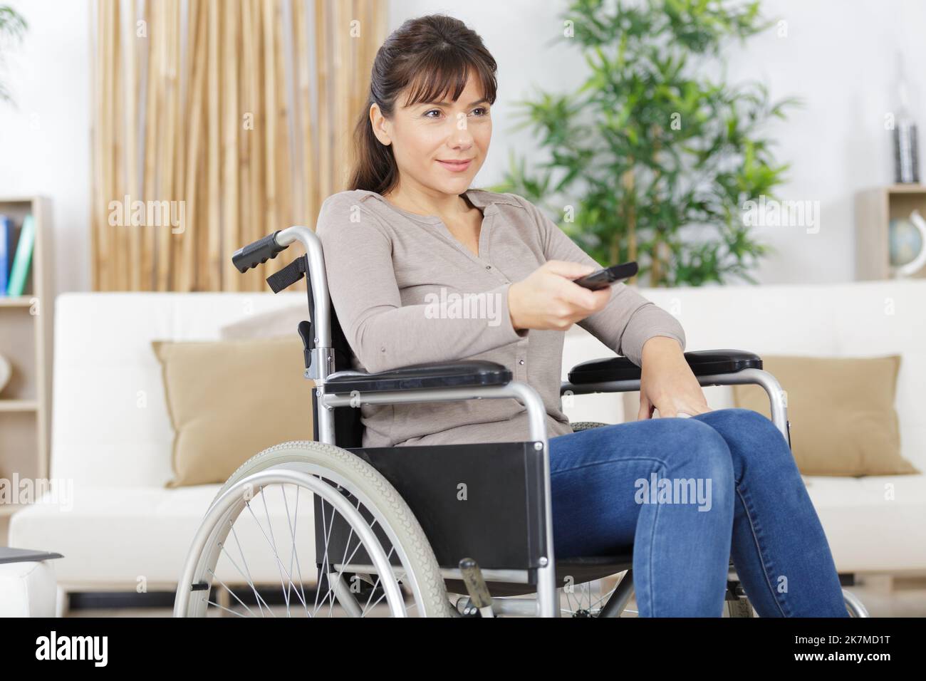 young disabled lady using remote control Stock Photo - Alamy