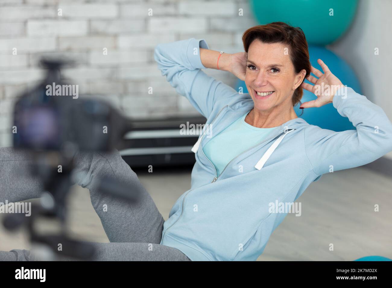healthy retired female making fitness tutorial Stock Photo - Alamy