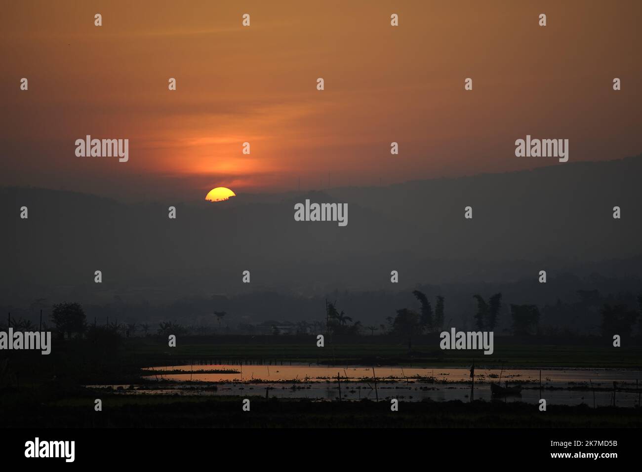 Nature silhouette background of sunset in Indonesia Stock Photo - Alamy