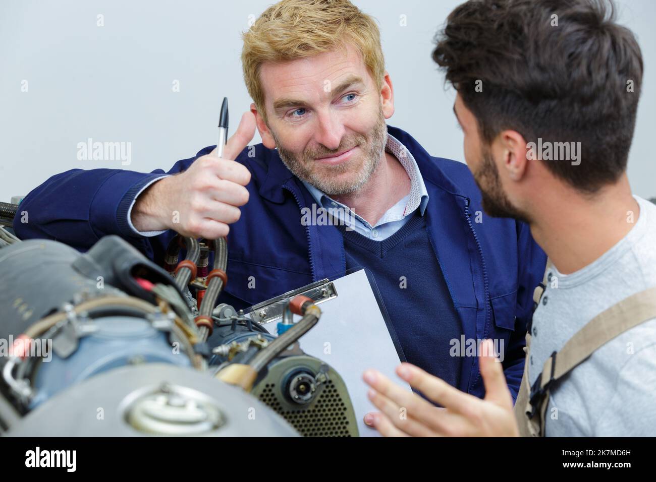 aircraft mechanical engineer giving an okay sign to apprentice Stock ...