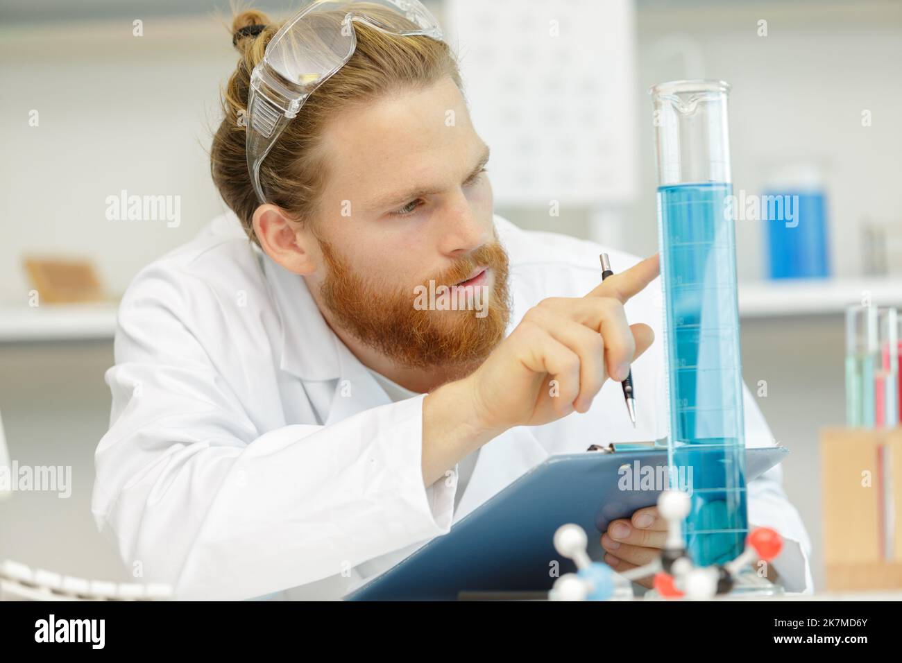 young scientist observing liquid reagent in laboratory Stock Photo - Alamy