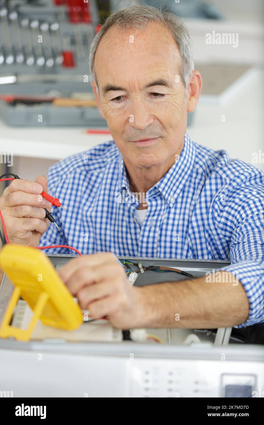 senior man using multi meter Stock Photo - Alamy