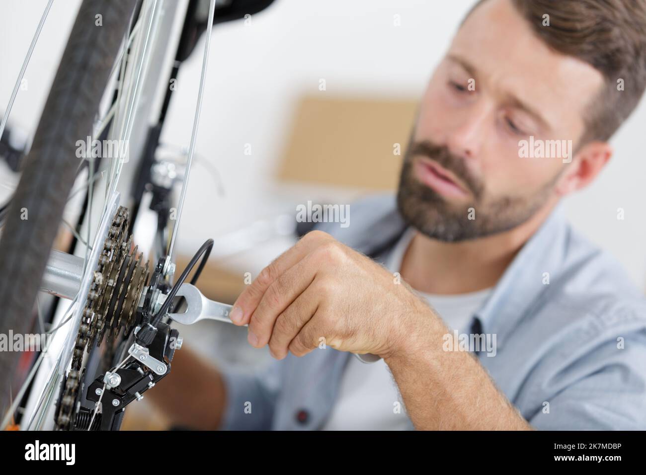 bicycle mechanic repairing bike in a workshop Stock Photo - Alamy