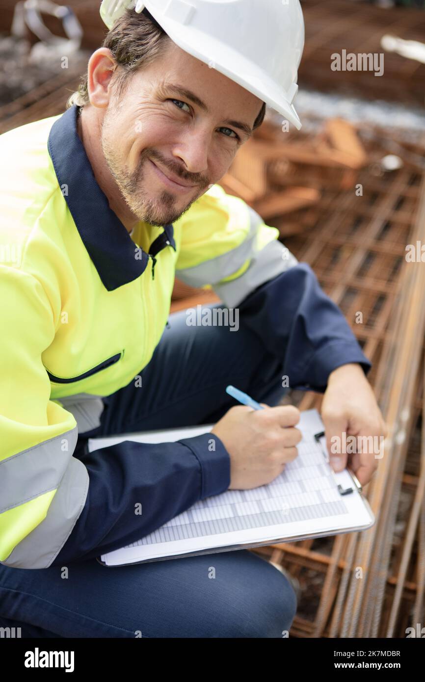 building inspector checking out the foundation of a new building Stock ...
