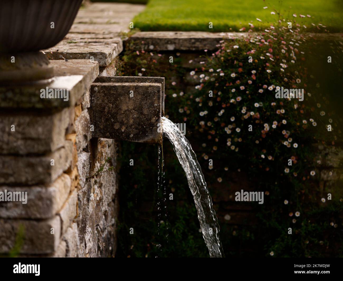 Close up of a water feature in the garden with water running from an ...