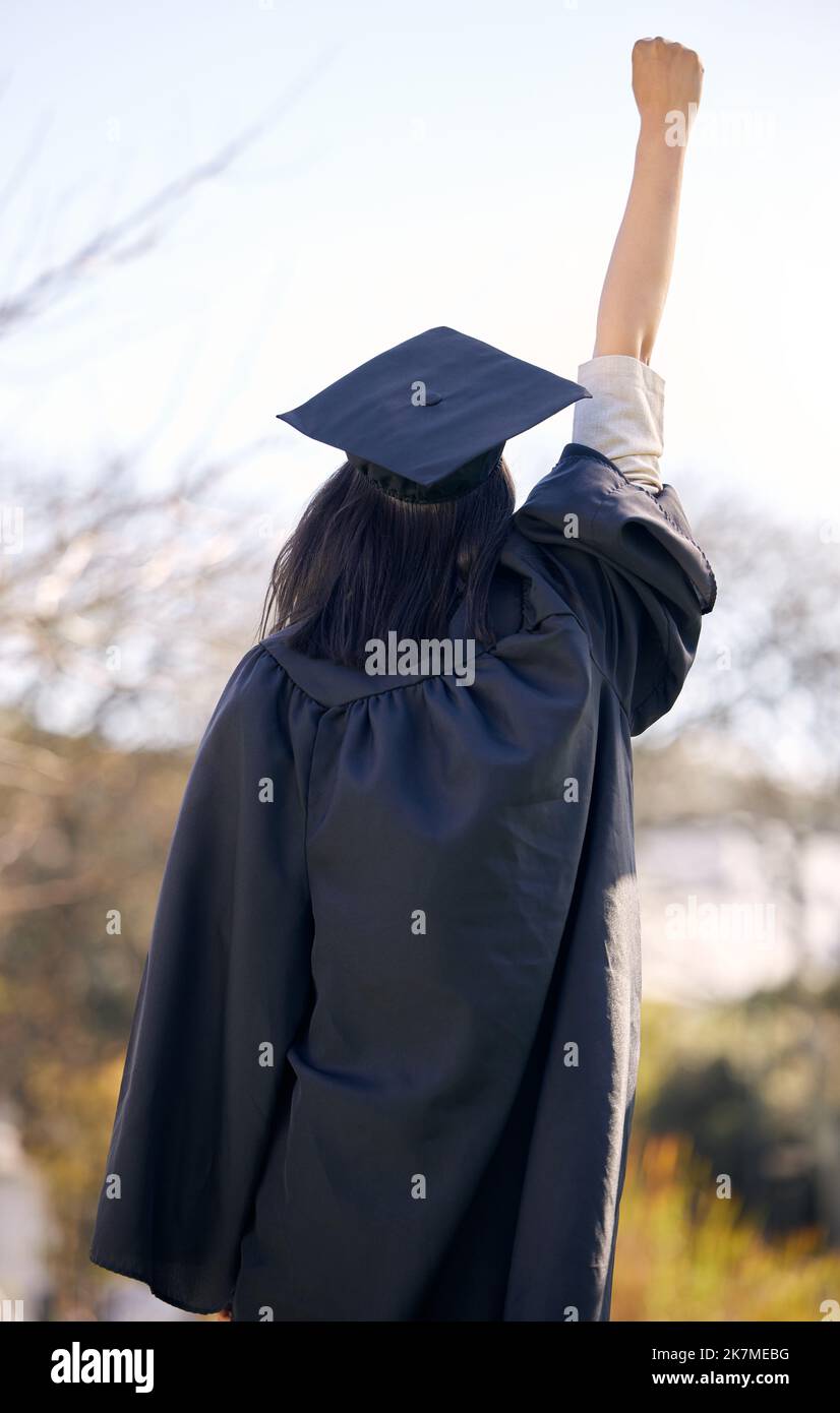 An important milestone, and I made it. Rearview shot of a young woman ...