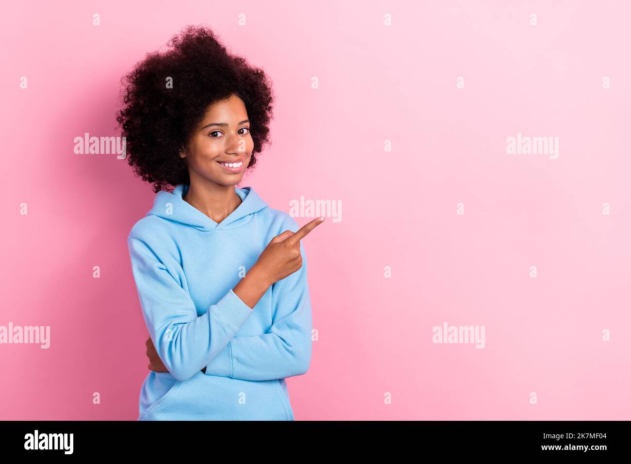 Photo of satisfied little girl wear stylish clothes hand direct empty ...