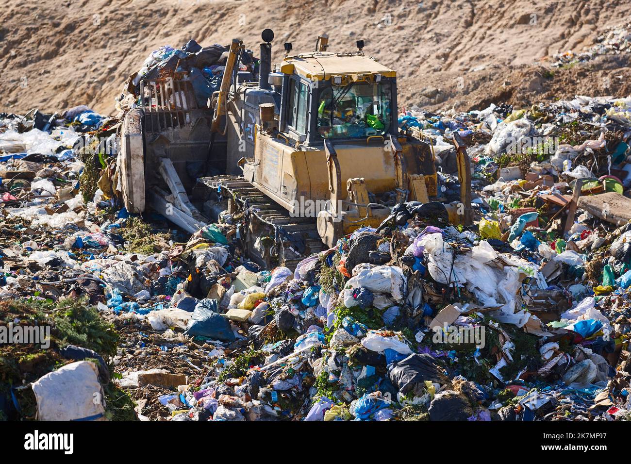 Heavy machinery shredding garbage in an open air landfill. Waste Stock ...