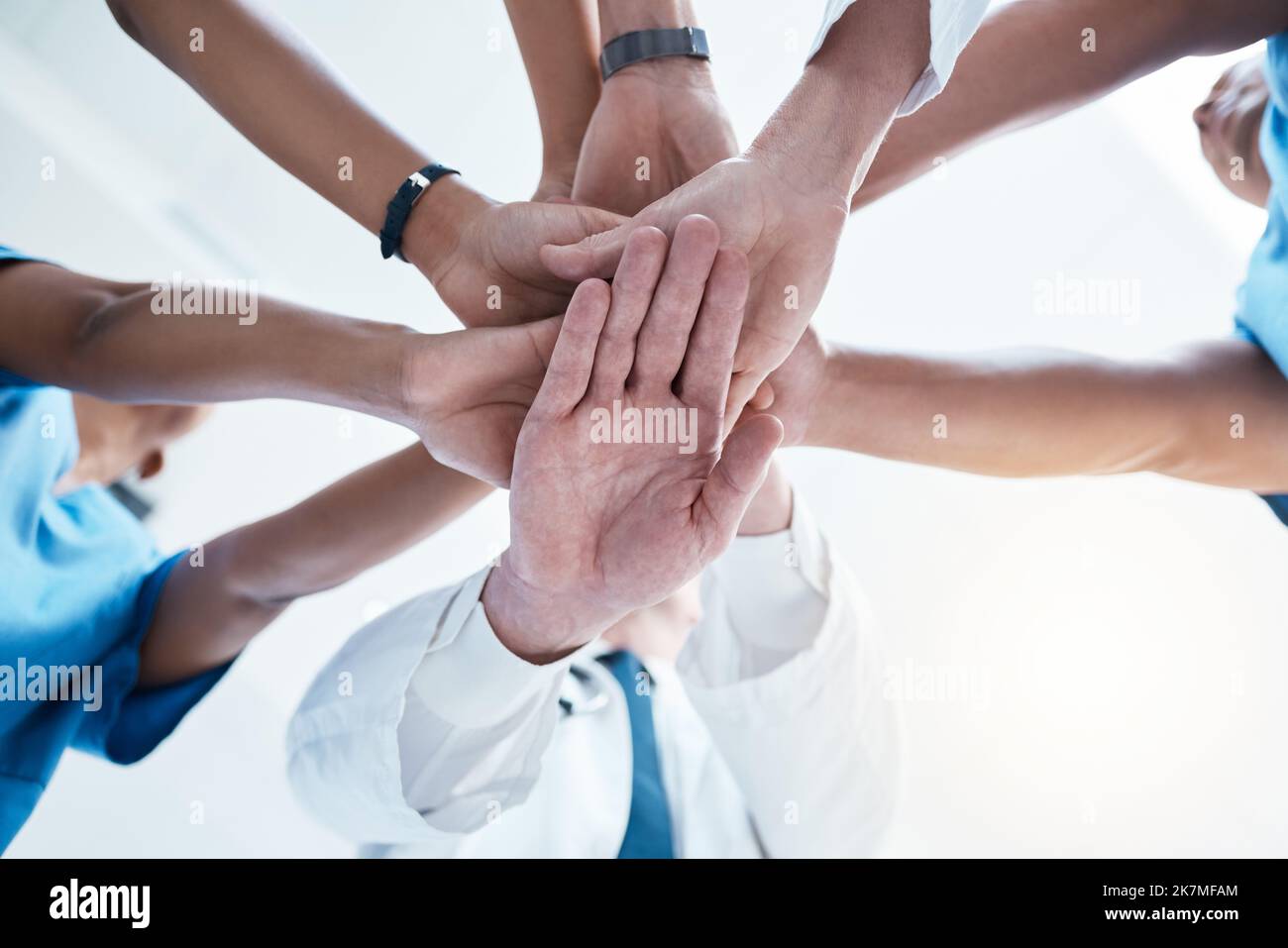 Below, group and hands stack for medical, staff and teamwork in ...
