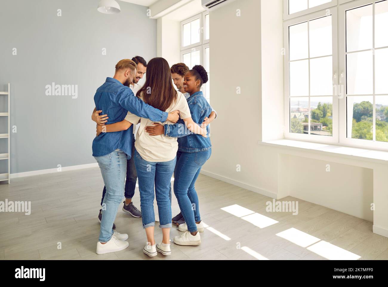 Team of happy multiracial business people standing in office and ...