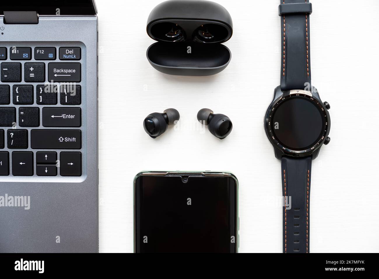 Laptop, smartphone, Wireless headphones and watch on white background ...