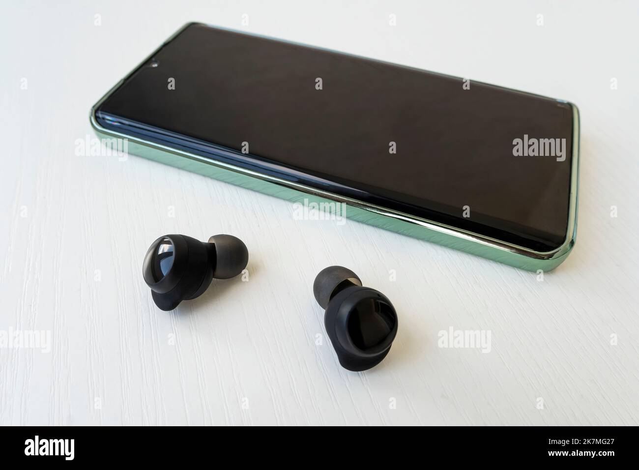 Smartphone and wireless headphones or earbuds top view Music technology ...