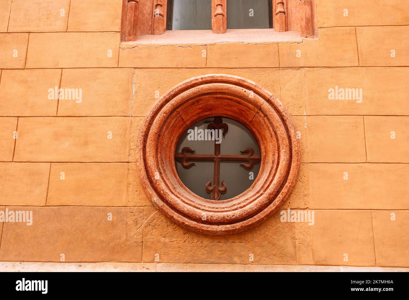 Old antique round window in an dirty wall of Valencia monastery, Spain ...