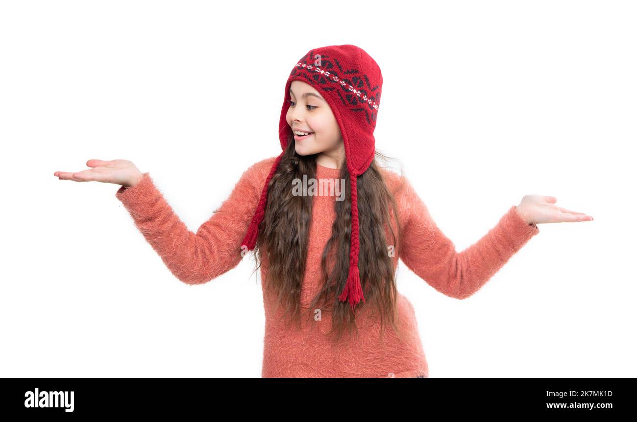teen girl model in earflap hat presenting product with copy space. teen ...
