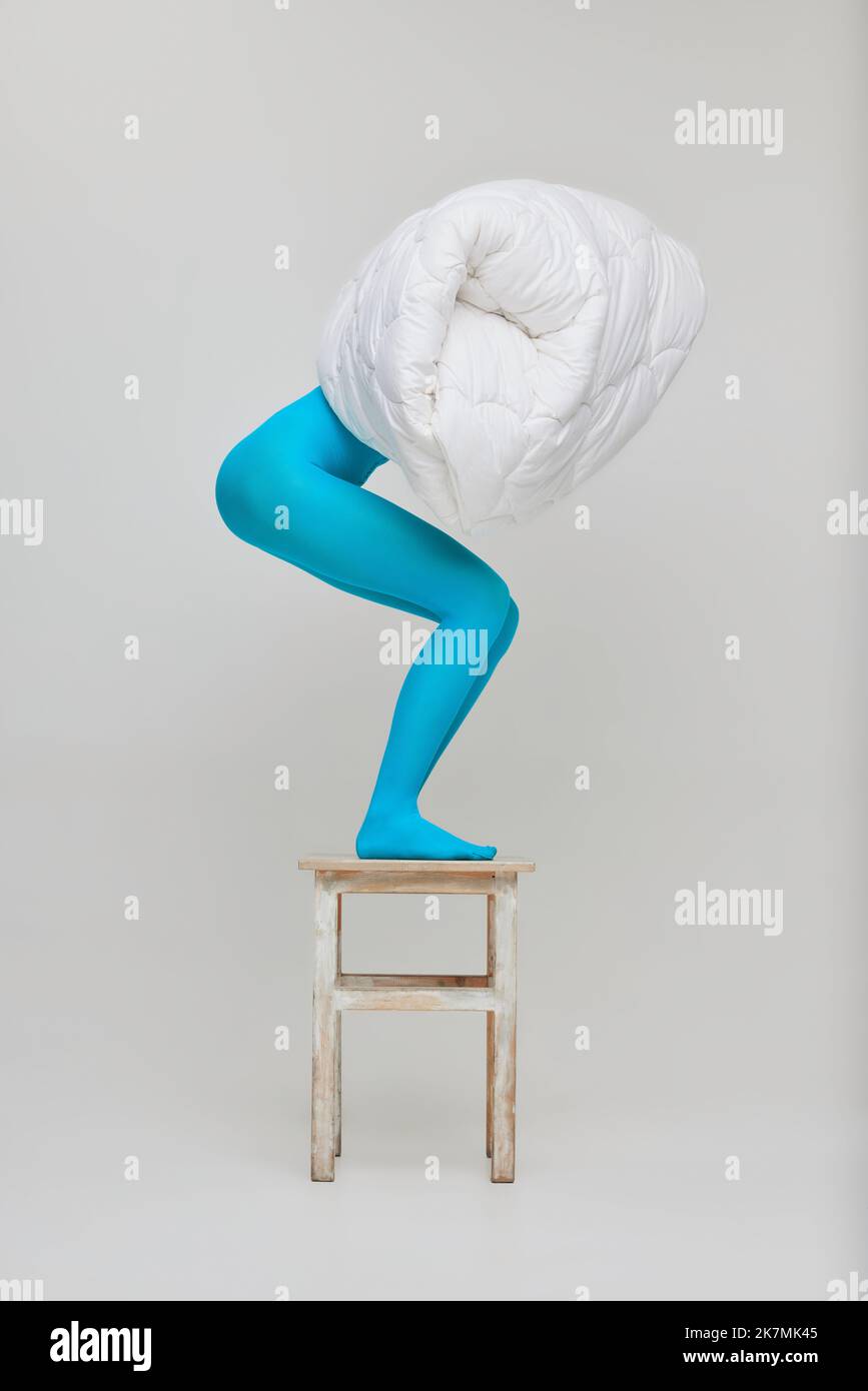 Portrait of young girl in blue tights with head covered with blanket ...